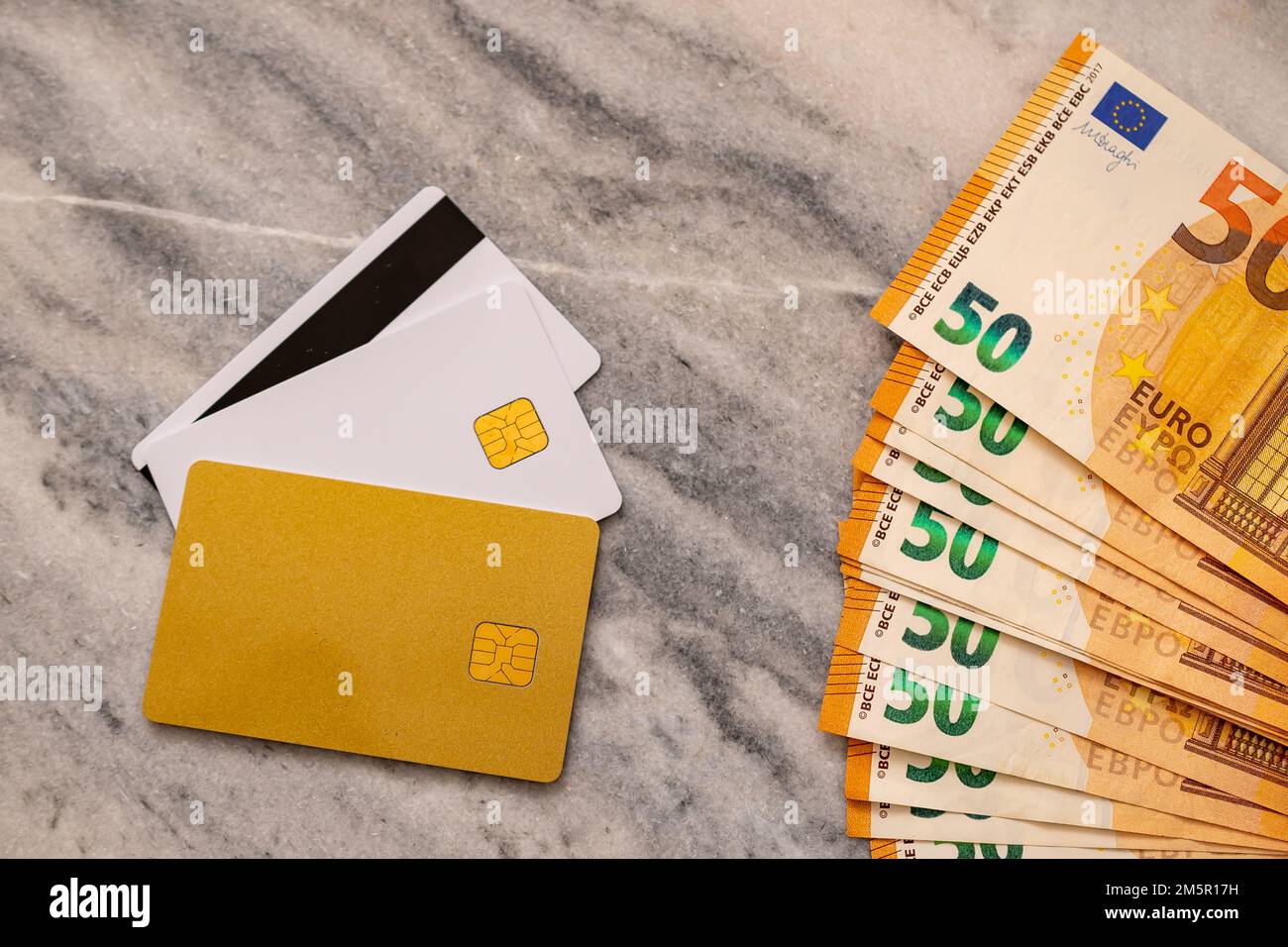 Close-Up Part Of 50 Euro Banknotes And Bank cards. Concept Of Comparing ...