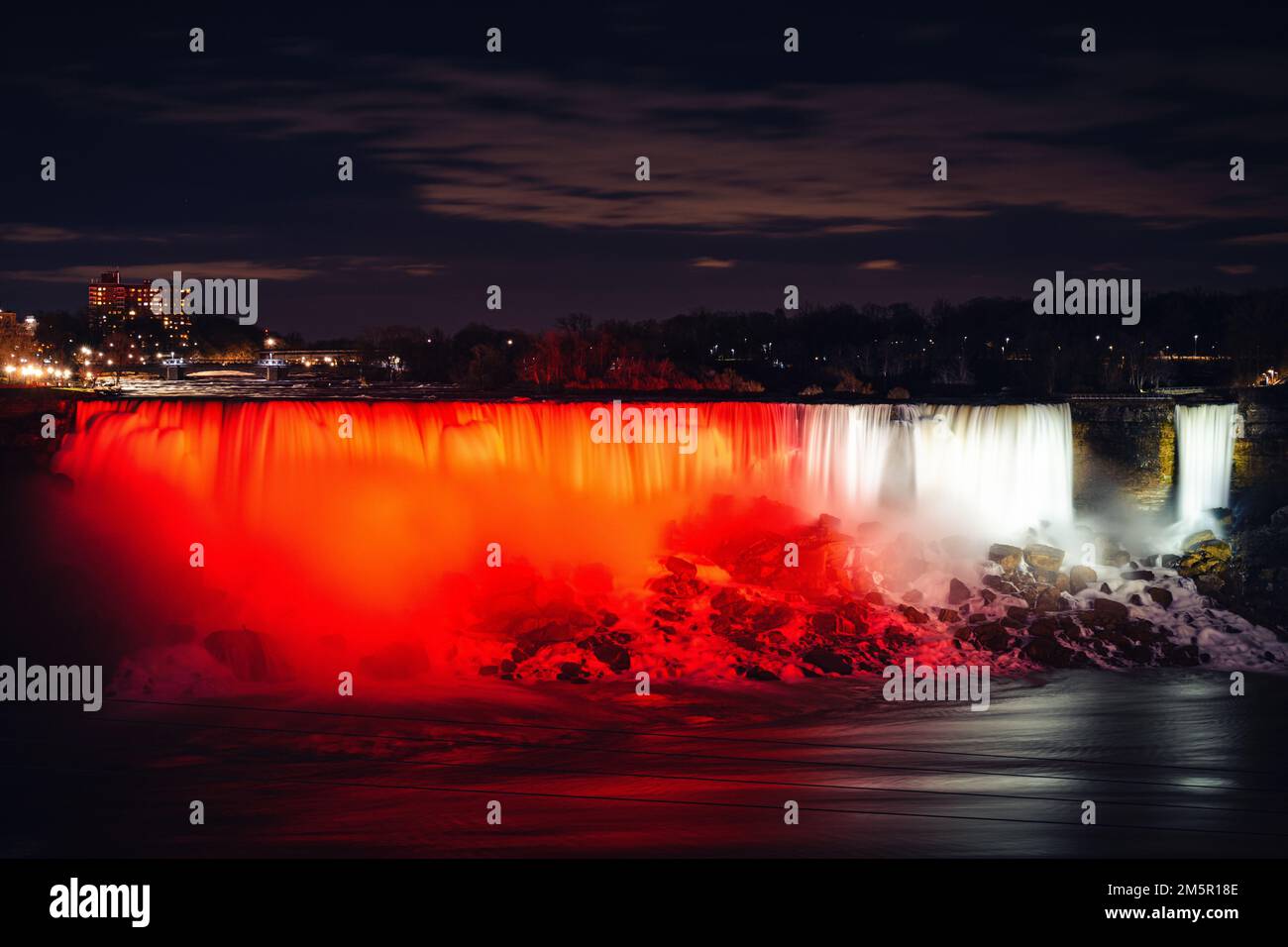 A scenic view of American Falls illuminated with lights in Niagara ...