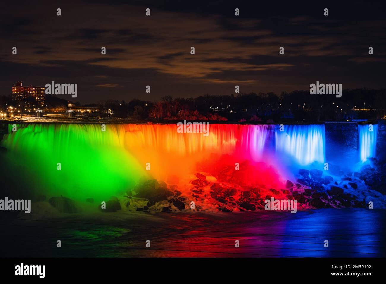A scenic view of American Falls illuminated with lights in Niagara ...
