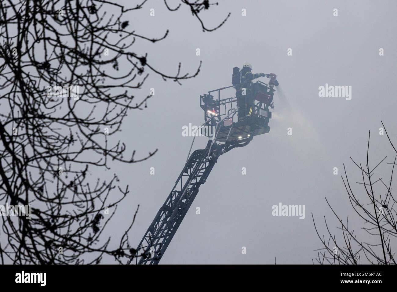 Wehr, Germany. 30th Dec, 2022. A firefighter stands on a turntable ...