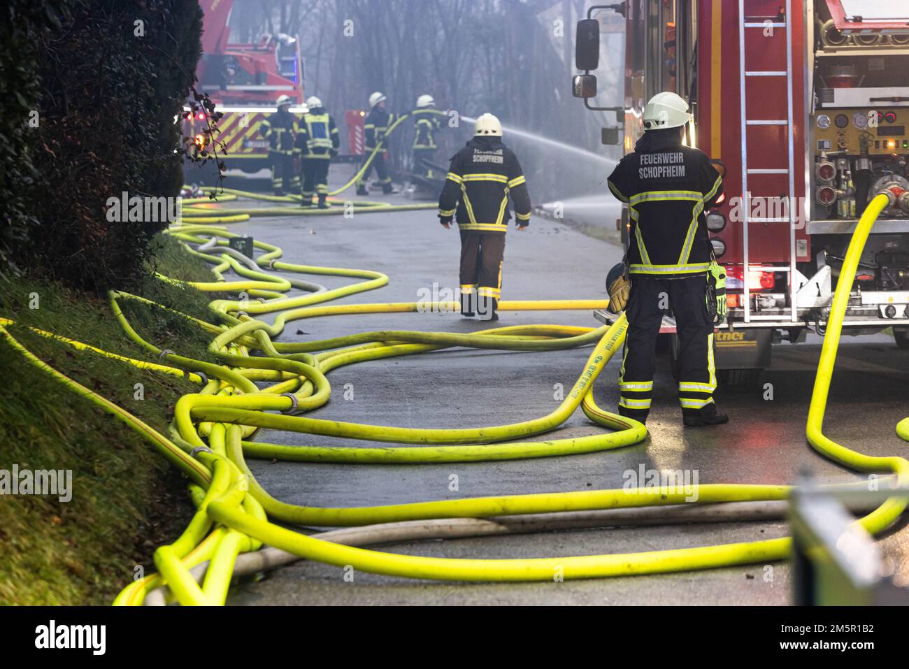 Wehr, Germany. 30th Dec, 2022. Fire hoses lie crisscrossed on an ...
