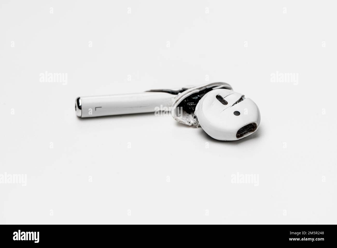 A broken Apple Airpod (wireless headphones) sits lifeless and non ...