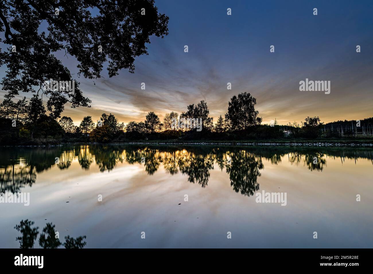 A stunning sunset reflected on a body of water Stock Photo - Alamy