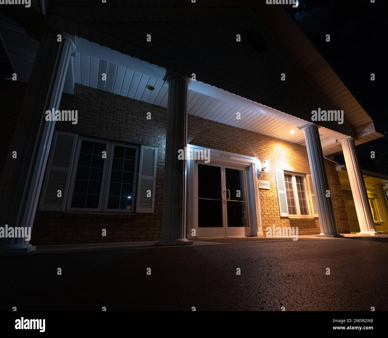 The illuminated building entrance at night Stock Photo - Alamy