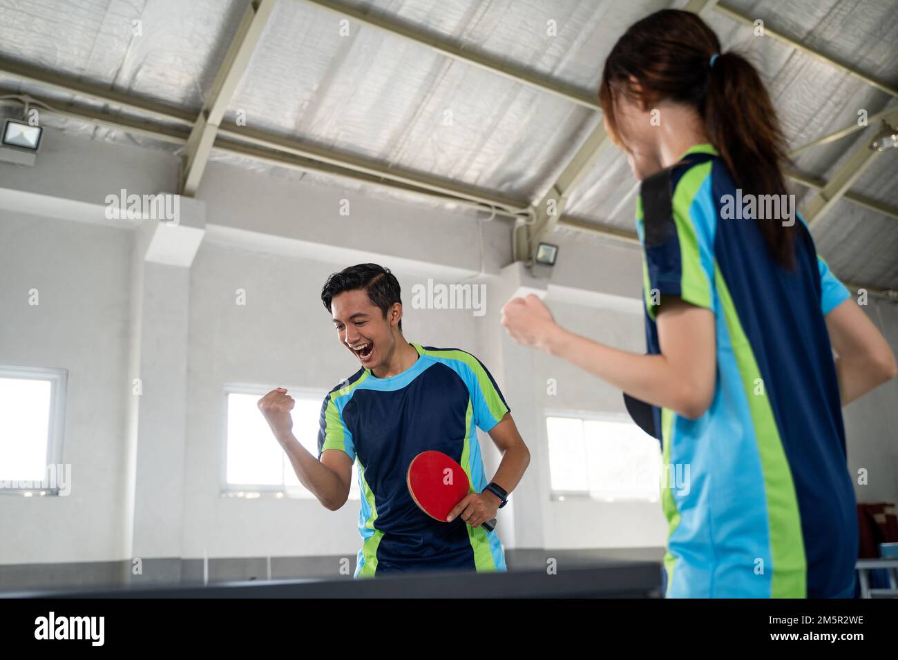 Two ping pong players competing with fists Stock Photo - Alamy