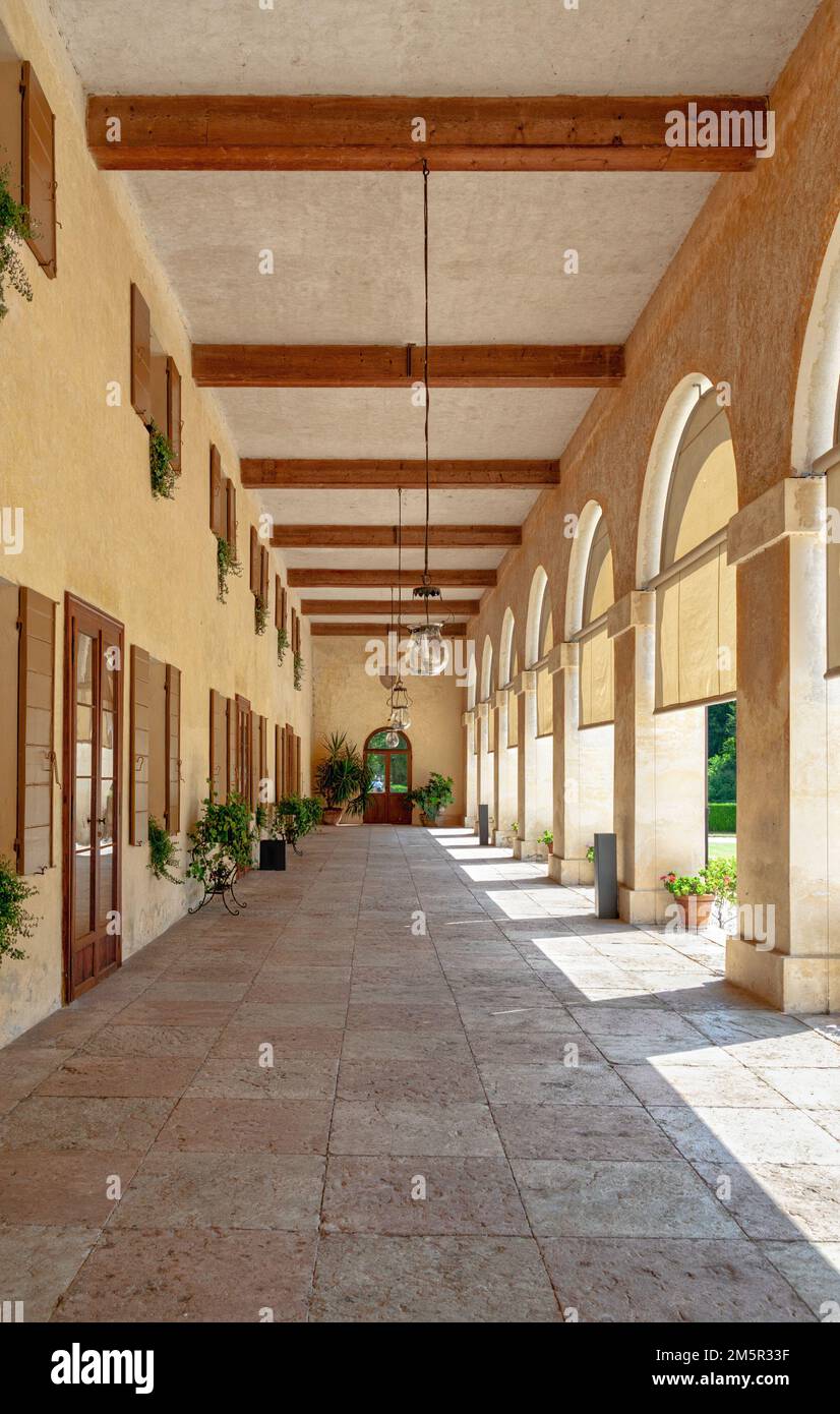 Arched corridor of Villa Emo barchessa with wooden beams in morning ...