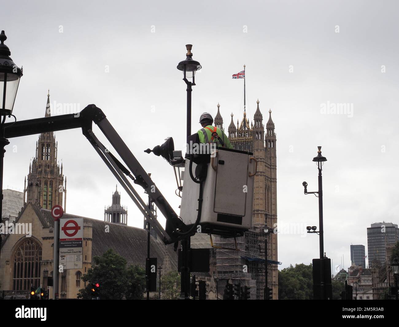LONDON, UK - CIRCA OCTOBER 2022: Man working on crane with a platform ...