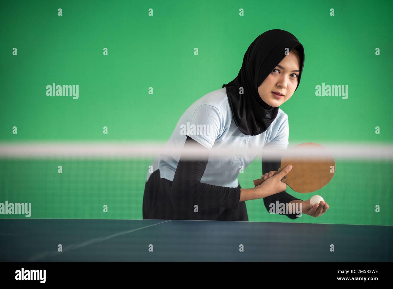 Young asian girl in hijab serving while playing ping pong Stock Photo ...