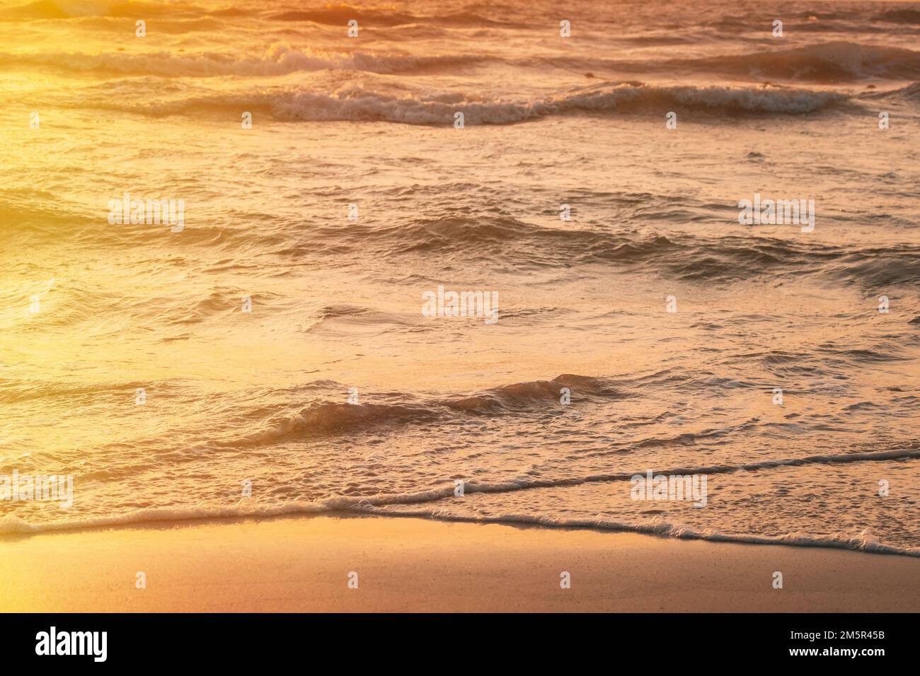 Sunset above sea. Riplpe sea ocean water surface with small waves ...