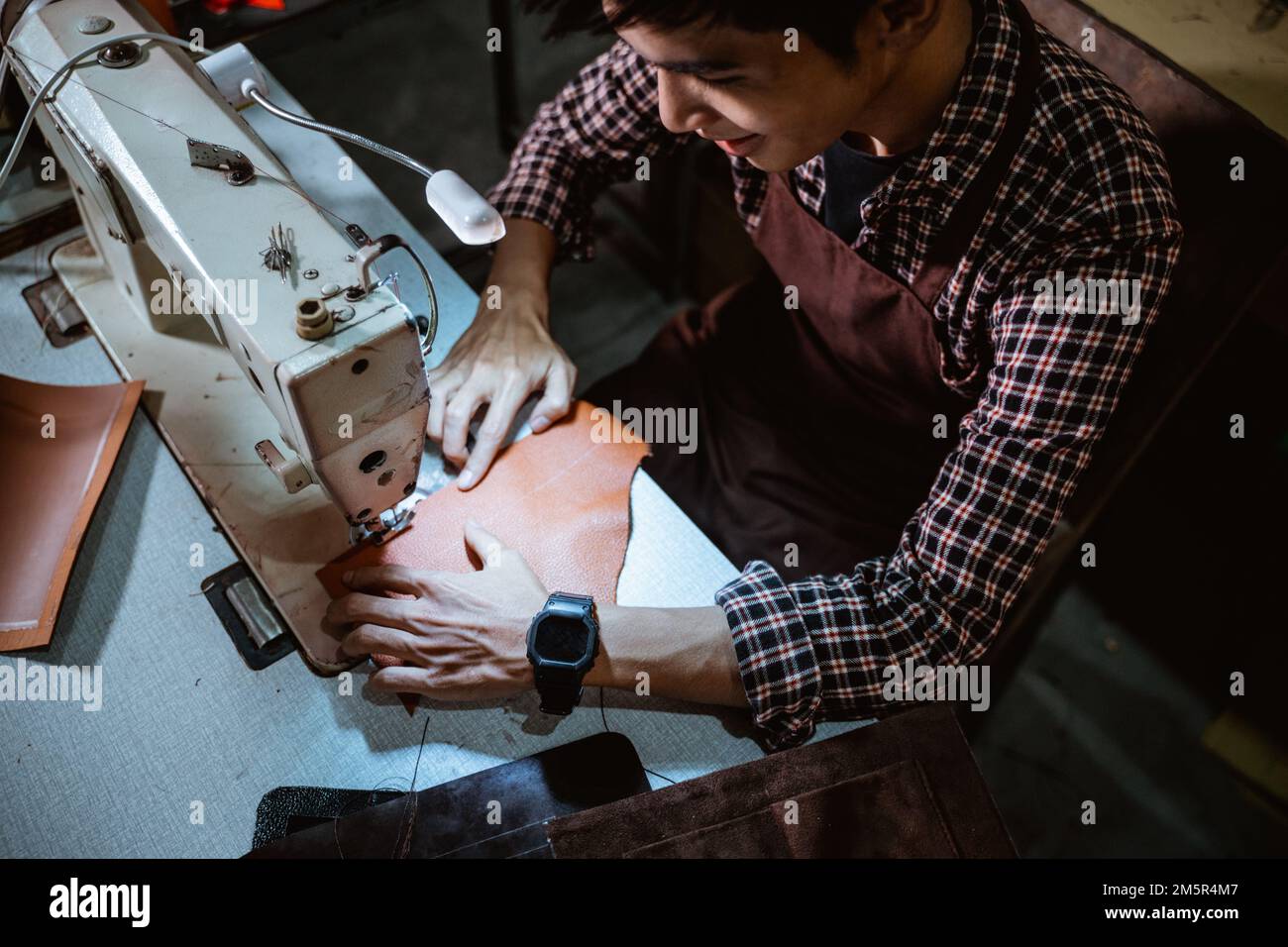 asian man tailor sewing leather using sewing machine Stock Photo - Alamy