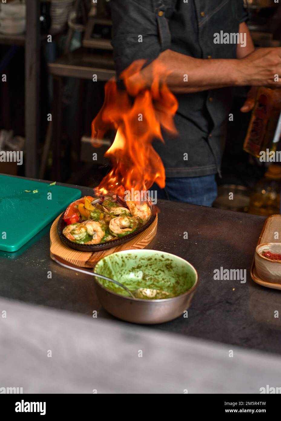 Traditional mexican beef fajitas on fire in the kitchen, kitchen ...