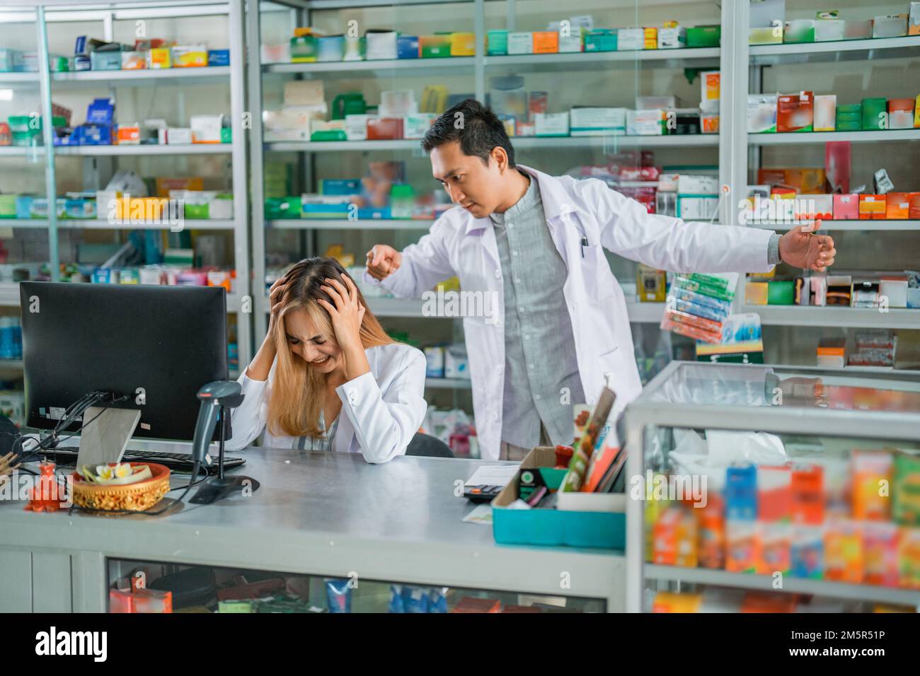 female pharmacist depressed at work being scolded by her friend Stock ...