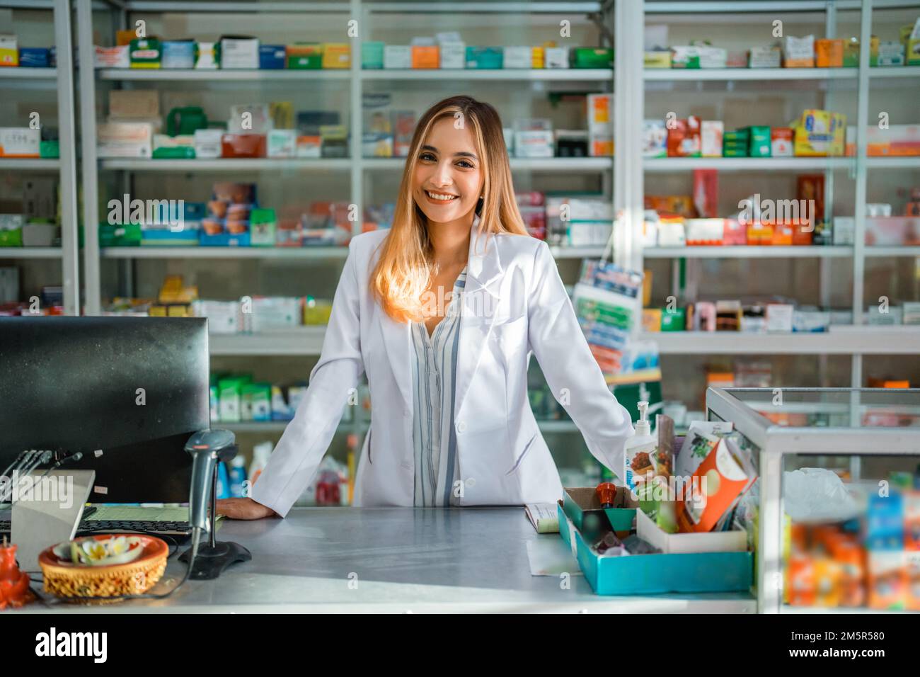 beautiful asian female pharmacist in uniform smiling at the camera ...