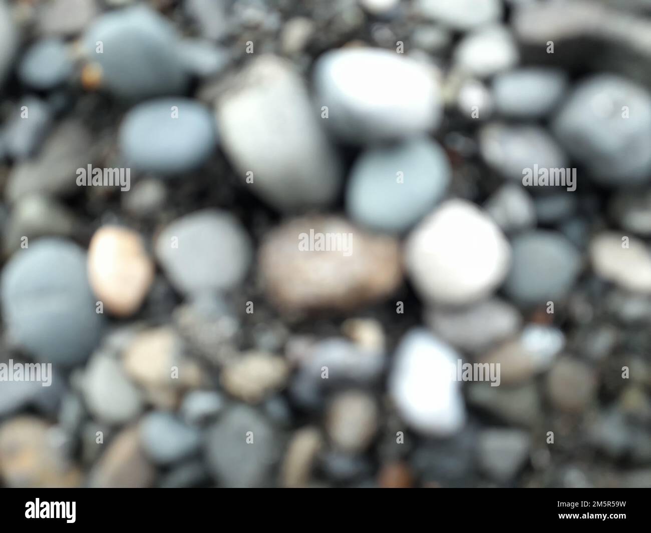 Blur photo or defocused abstract background of smooth small rocks on ...
