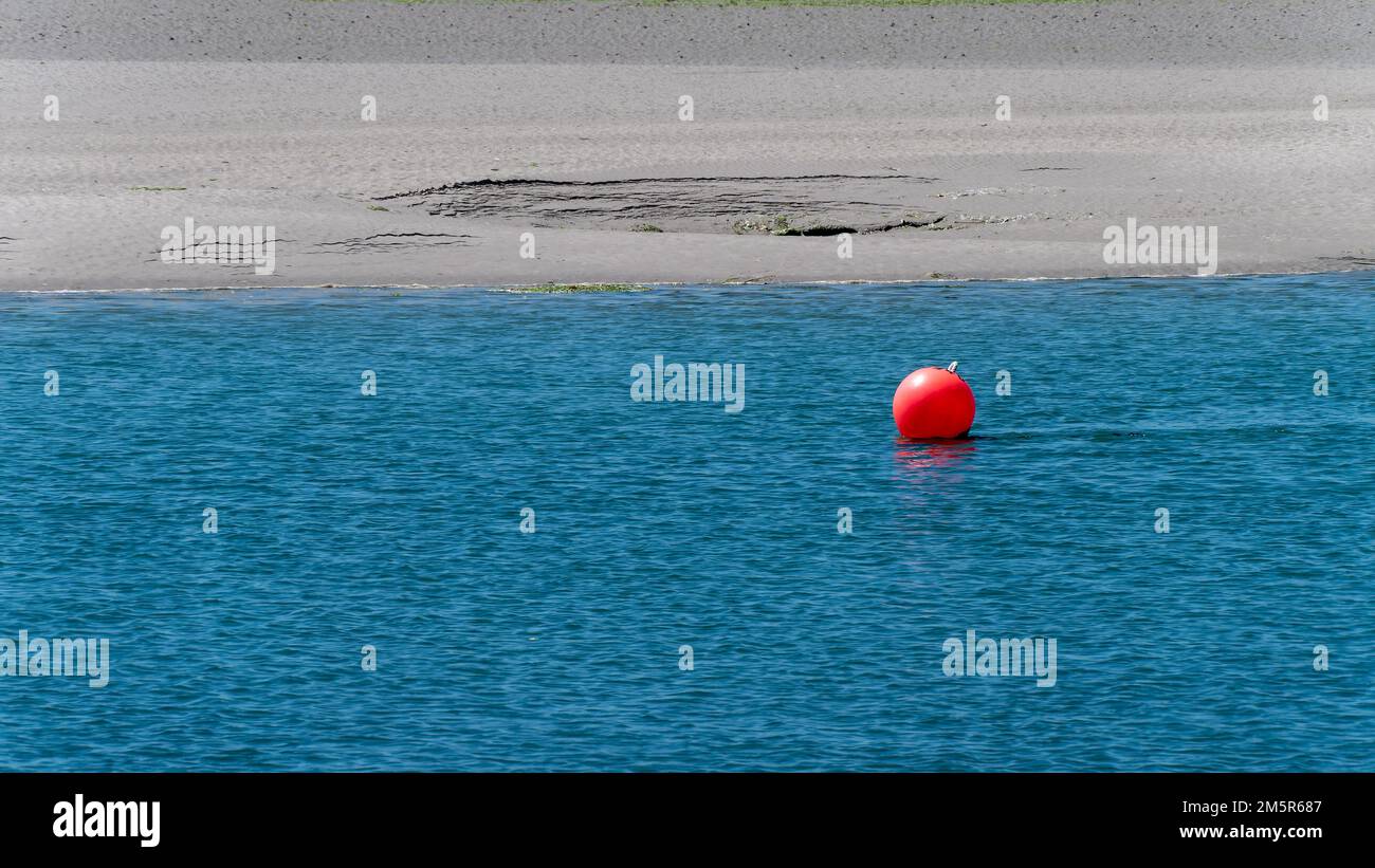 One orange sea buoy on the surface of blue water. Seascape, a copy ...