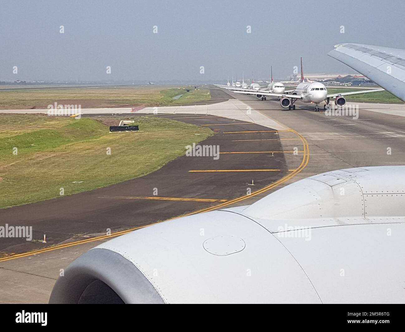 Picture of several airplanes on an airport runway waiting for takeoff ...