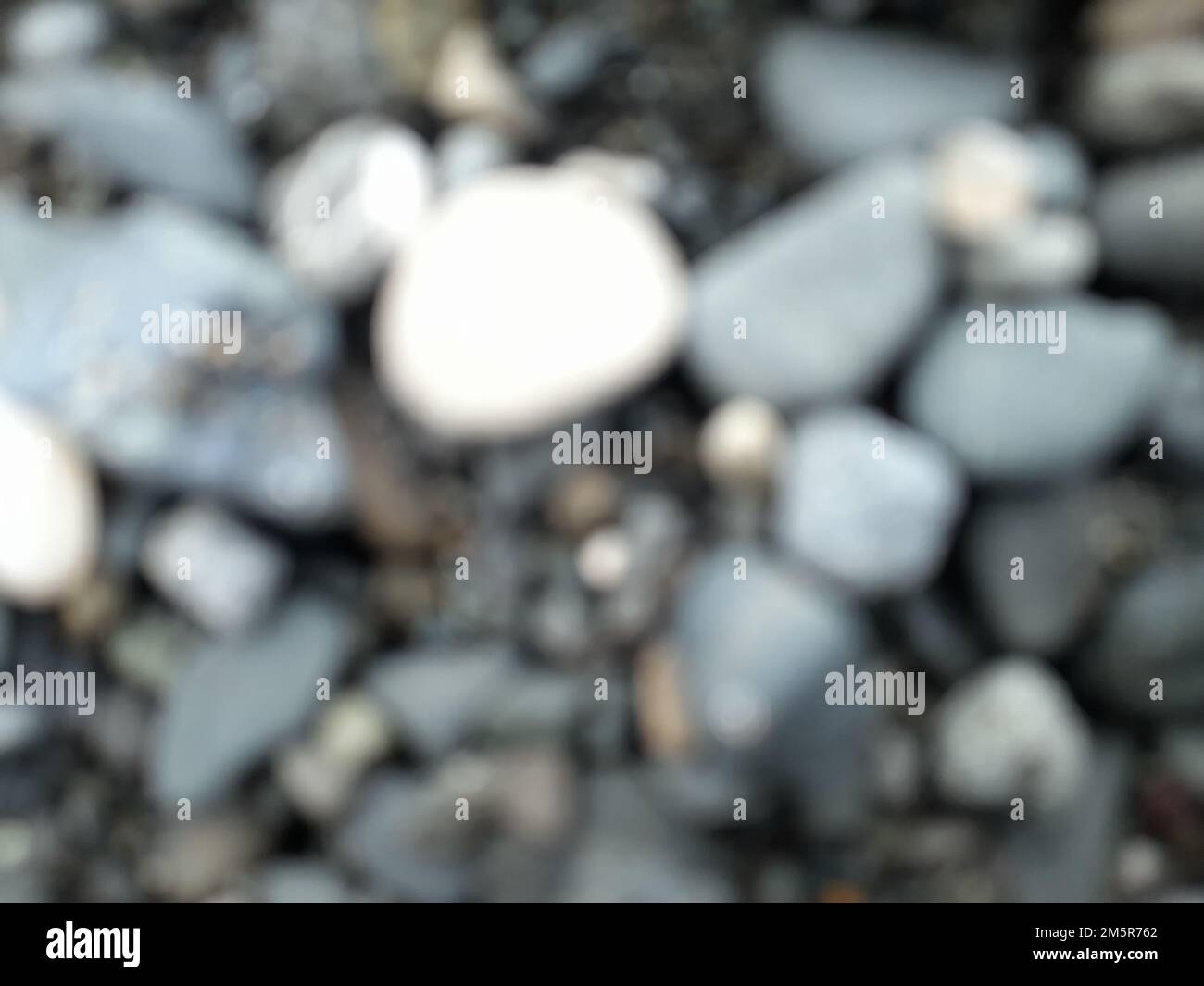 Blur photo or defocused abstract background of smooth small rocks on ...
