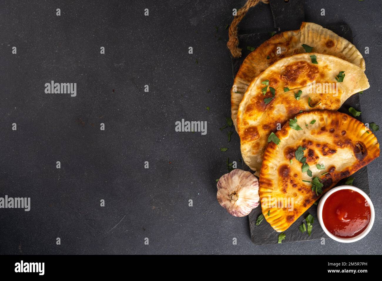 Chebureks, empanadas. Fried pies pasties, with meat and spices, on a ...