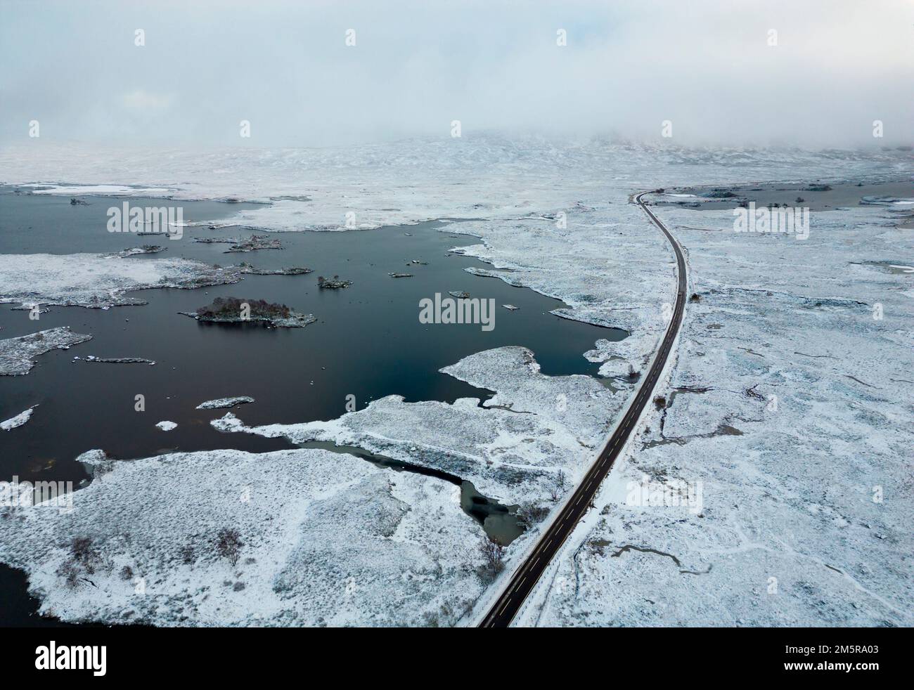 Aerial view of road crossing Rannoch Moor in winter snow, Scottish ...