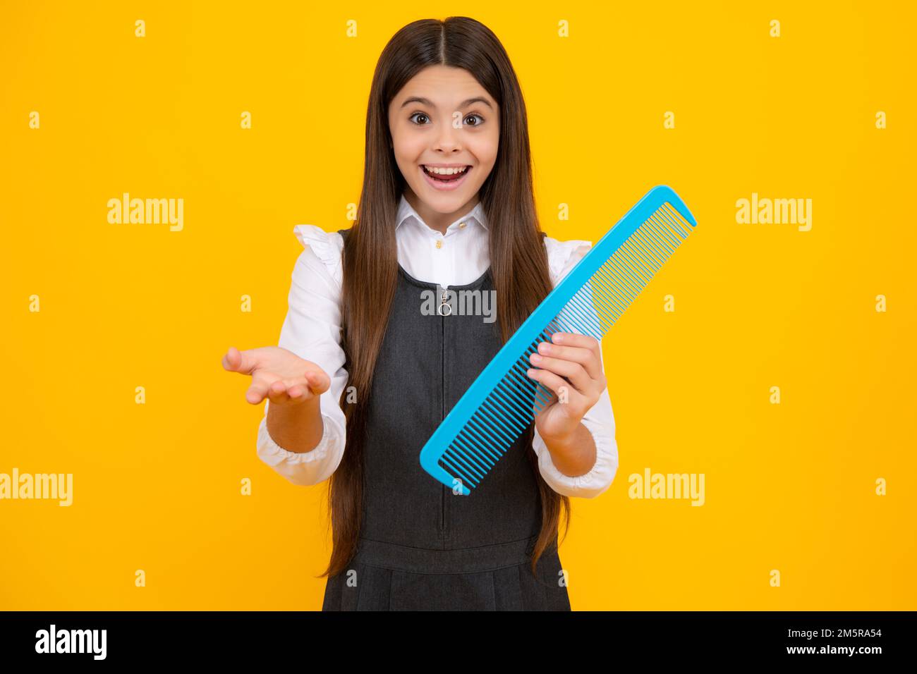 Teenager girl with long hair holding comb hairbrush for combing, beauty ...