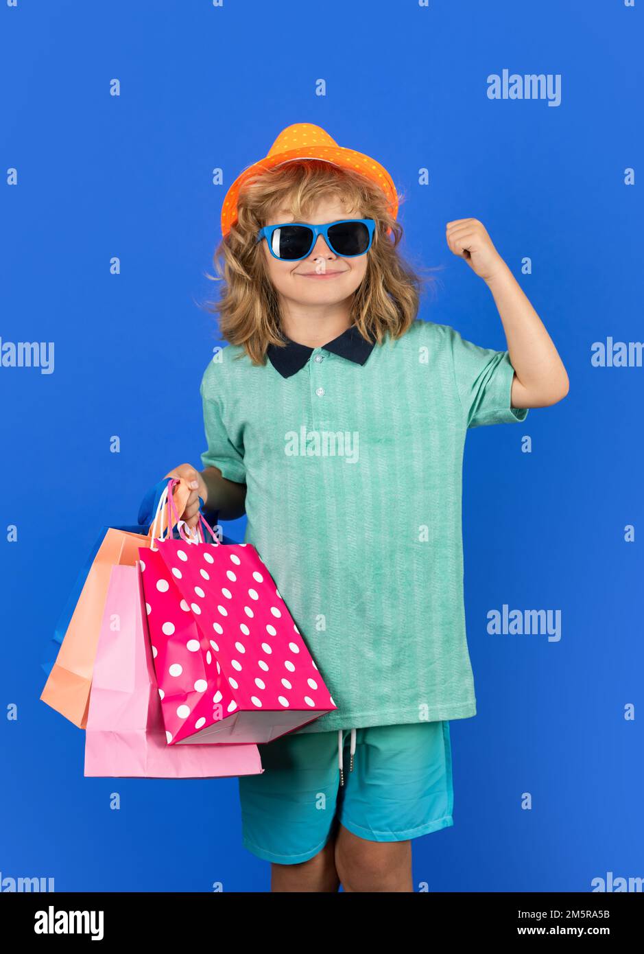 Little kid shopper. Child in fashion clothes on shopping. Kid with ...