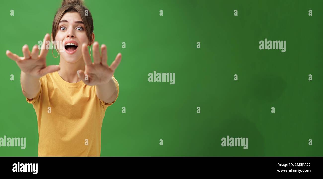 Excited and addicted goog-looking young woman reaching hands forward to ...