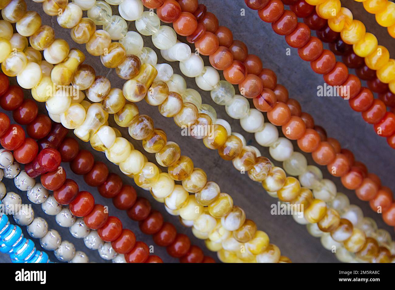 Many rosaries in various colors and materials are exposed at the shop ...