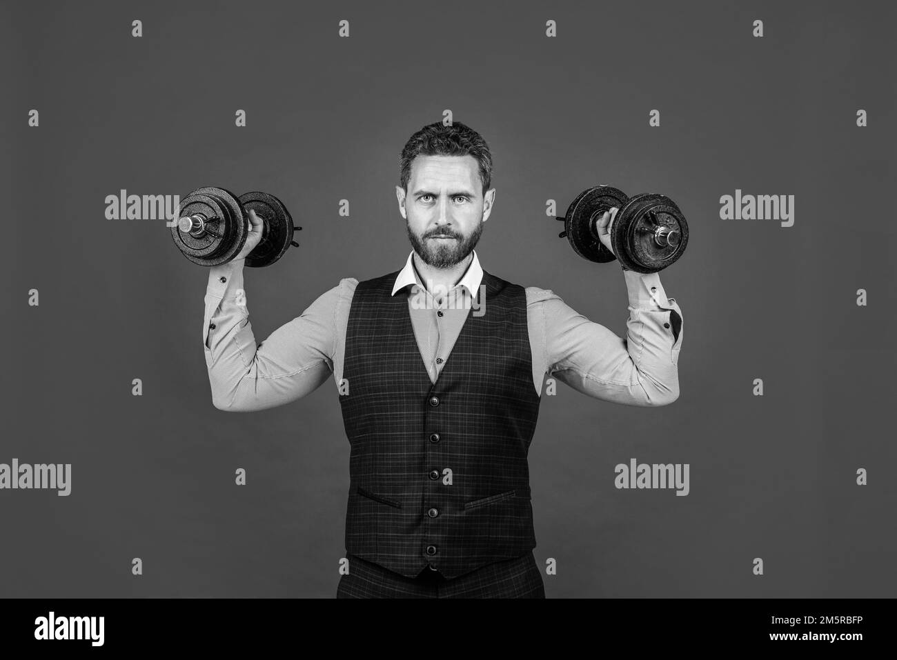 Work hard. Strong employee lift dumbbells red background. Building ...