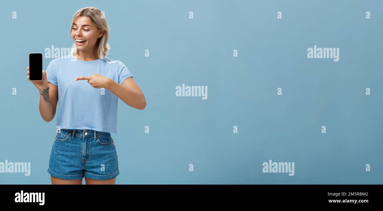 Portrait of delighted good-looking european female with blond haircut ...