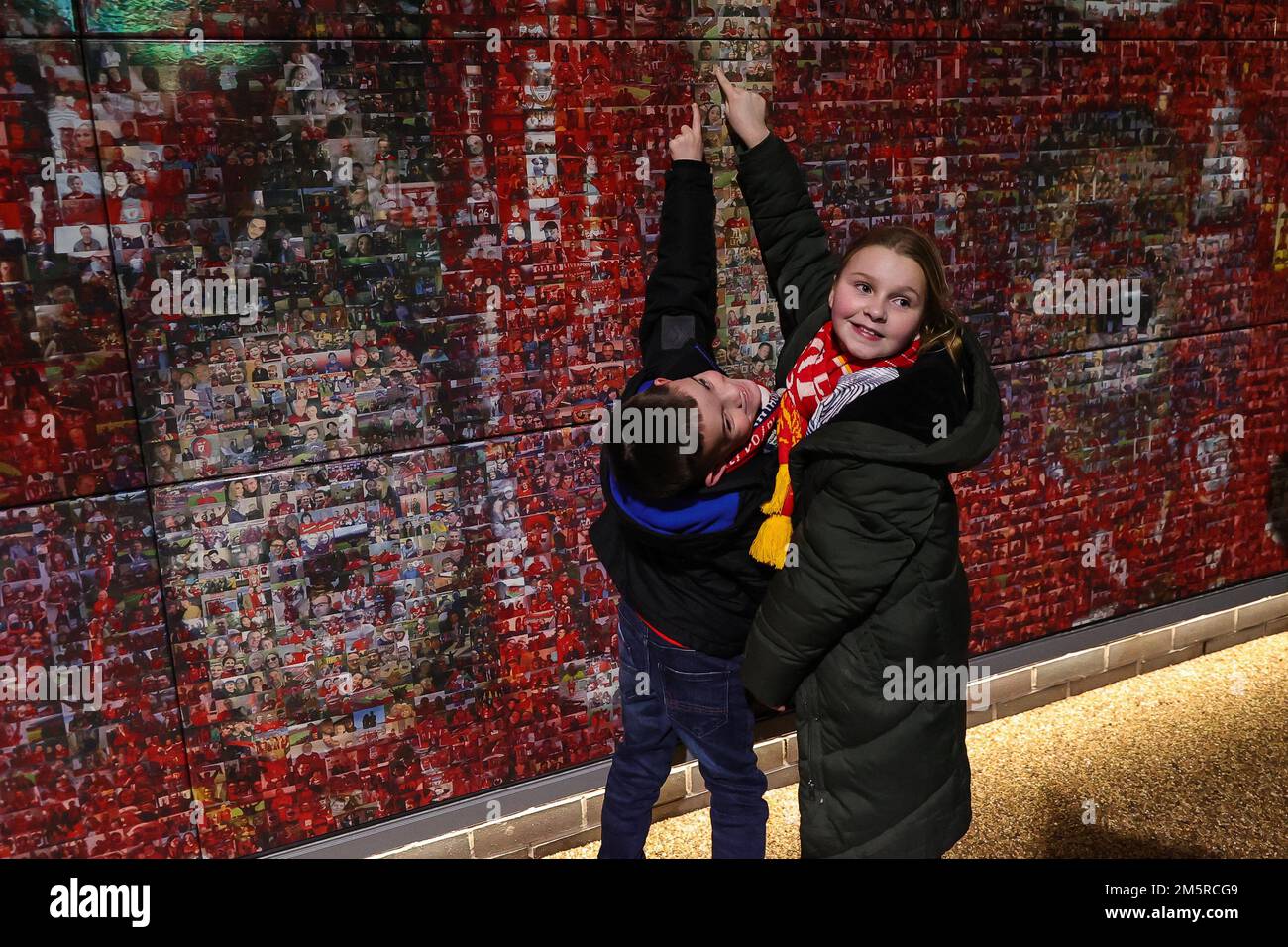 Fans look at he photo mural outside Anfield ahead of the Premier League ...