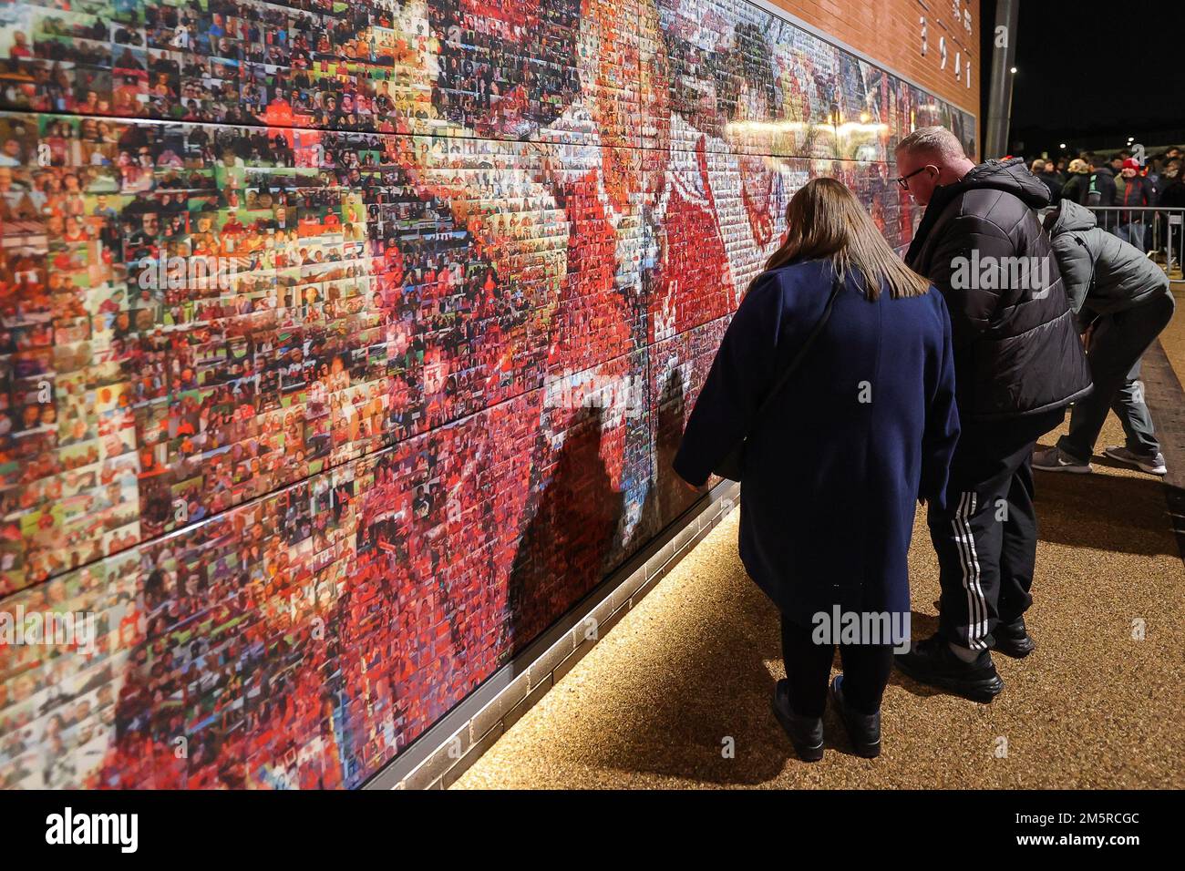 Fans look at he photo mural outside Anfield ahead of the Premier League ...