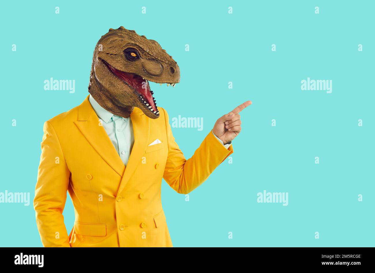 Cool man in trendy rubber dinosaur mask is pointing with his finger at ...