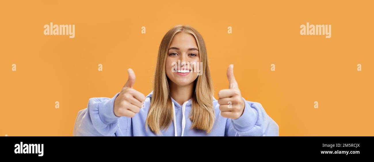 Portrait of happy optimistic woman showing thumbs up gesture and ...