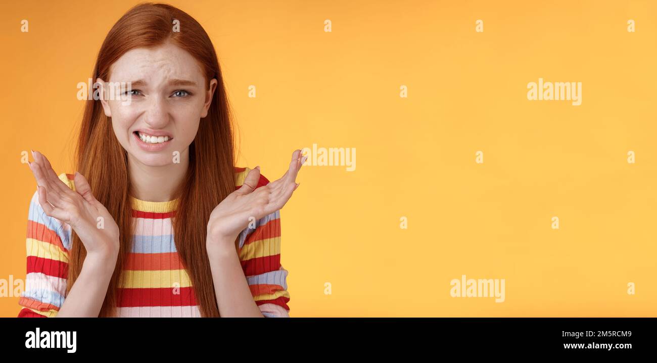 Awkward unhappy worried young redhead girl cringe feel sorry ...
