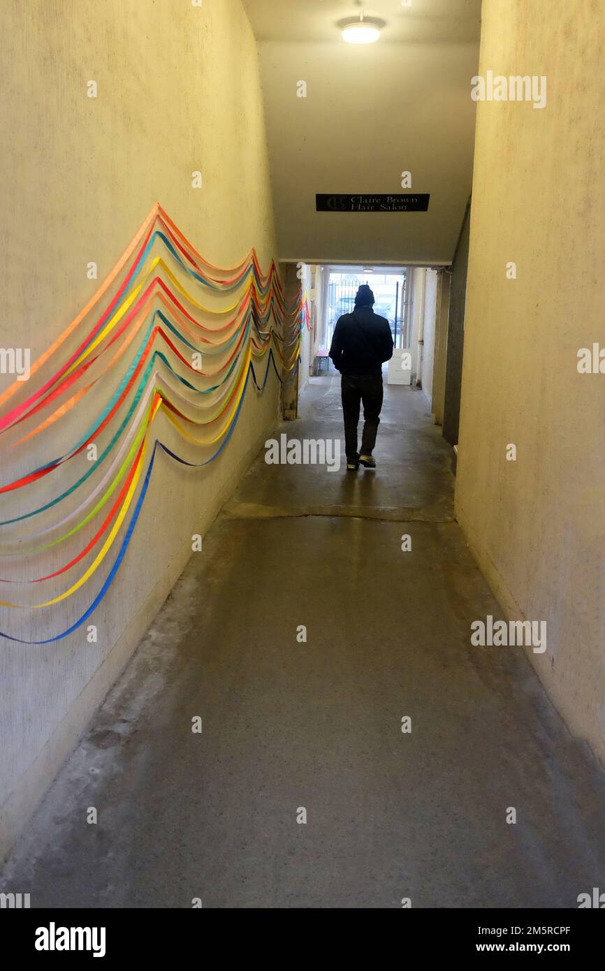 November 2022 - Man walking down a decorated alley way in Bath, England ...