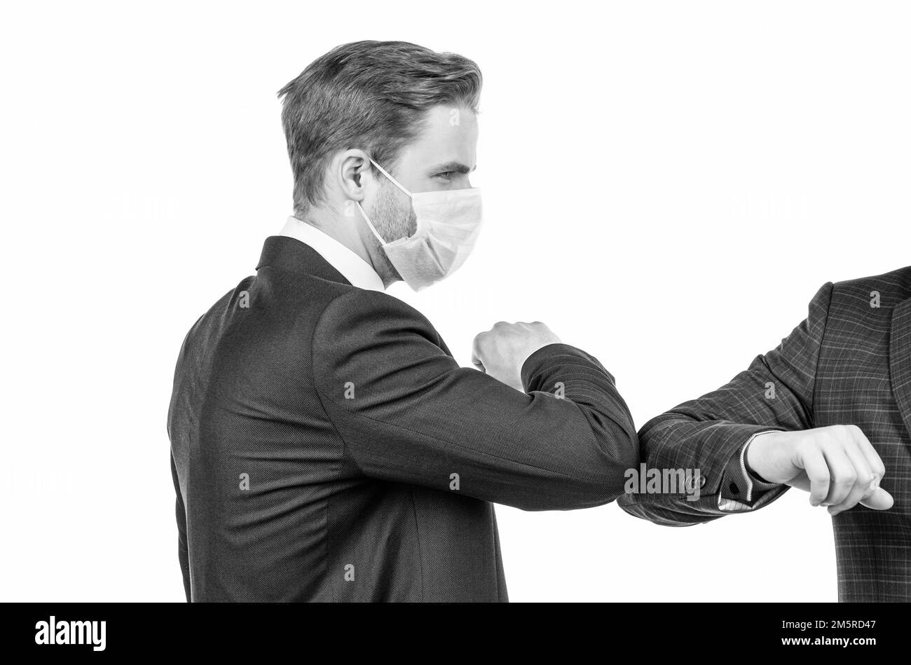Elbow bump is the new handshake. Broker in face mask elbow bump with ...