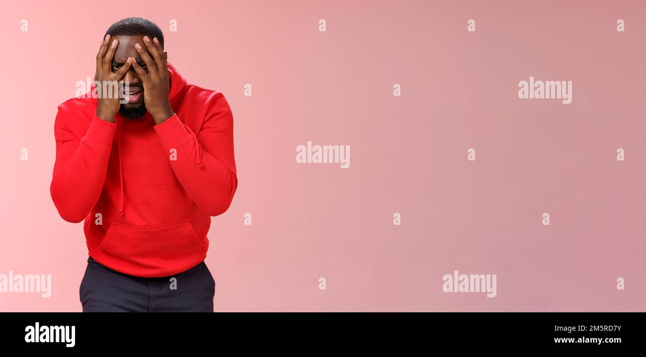 Shocked upset young african american bearded guy in red hoodie facepalm ...