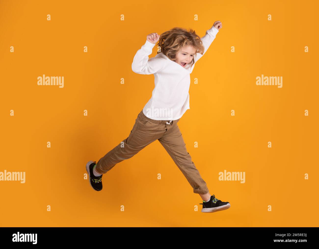Full length of excited kid jumping. Full body of little child jump wear ...
