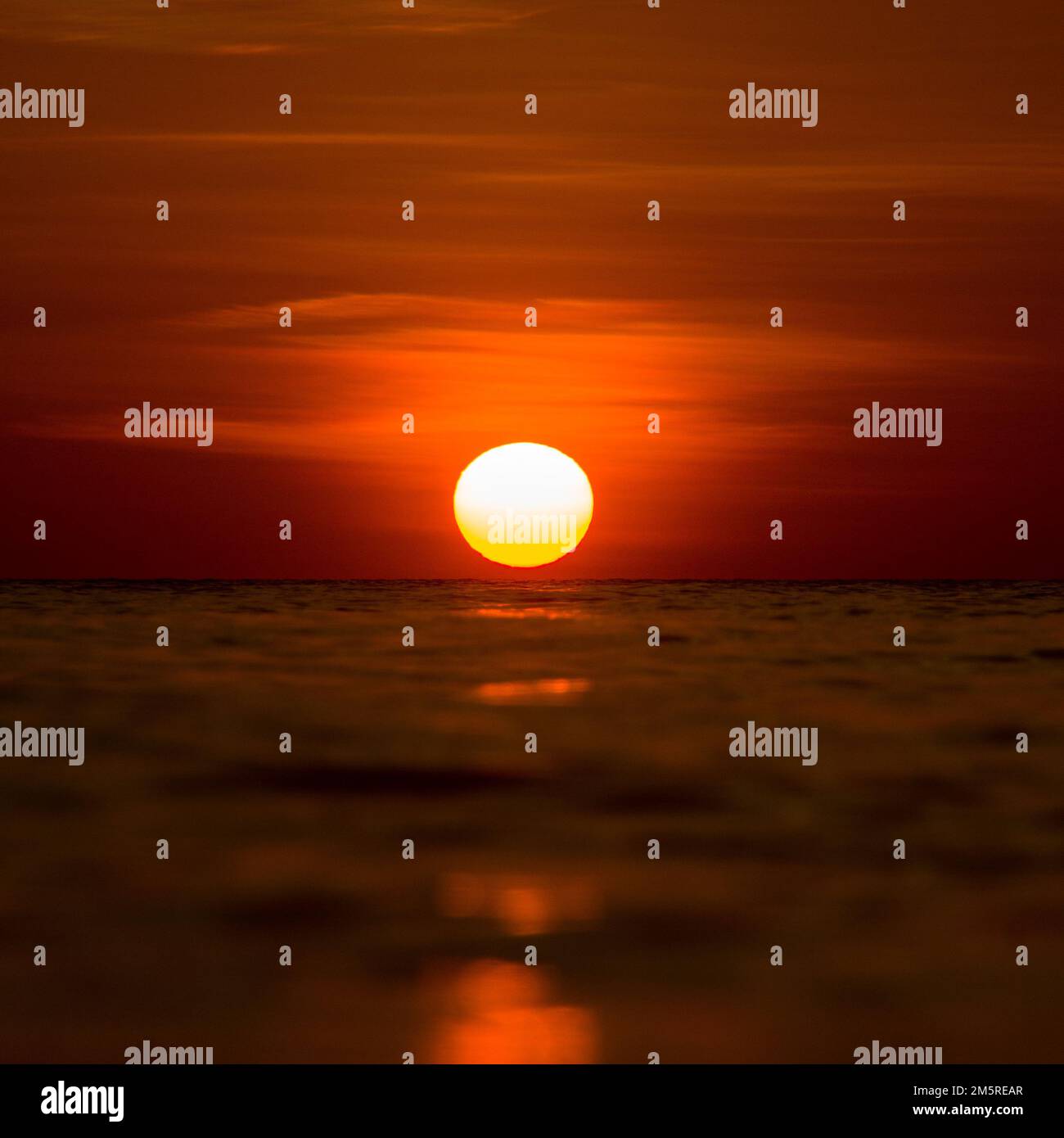 An image of a sun above a water surface during a golden hour Stock ...