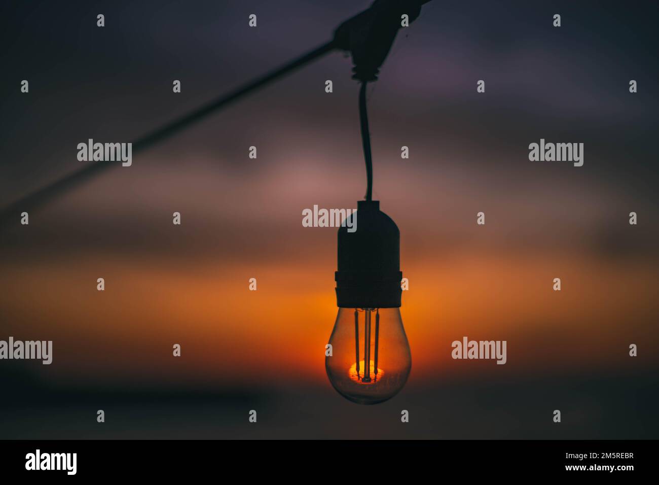 A selective focus of a light bulb during a beautiful sunset Stock Photo ...