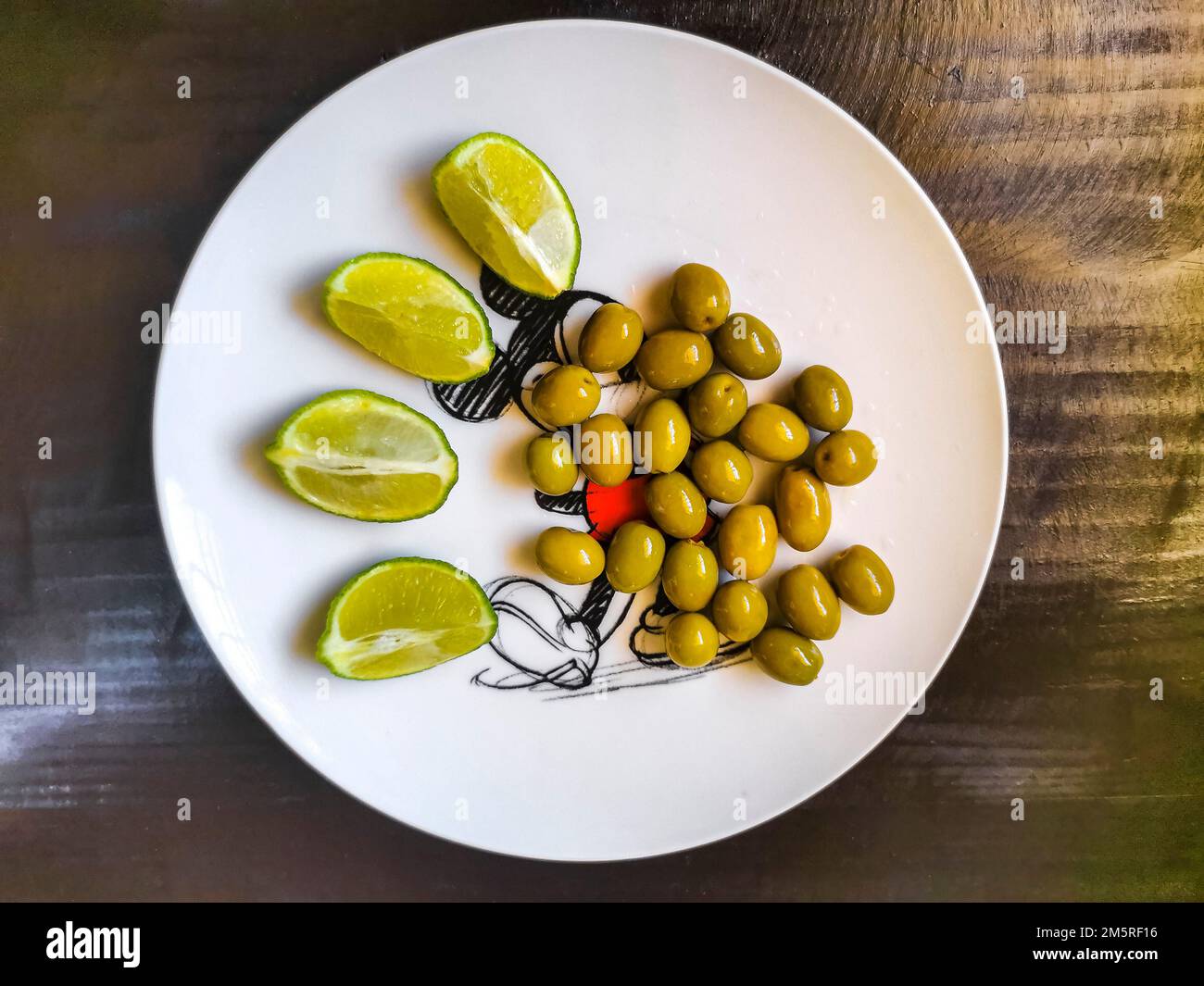 Green olives and limes on white plate in Playa del Carmen Quintana Roo ...