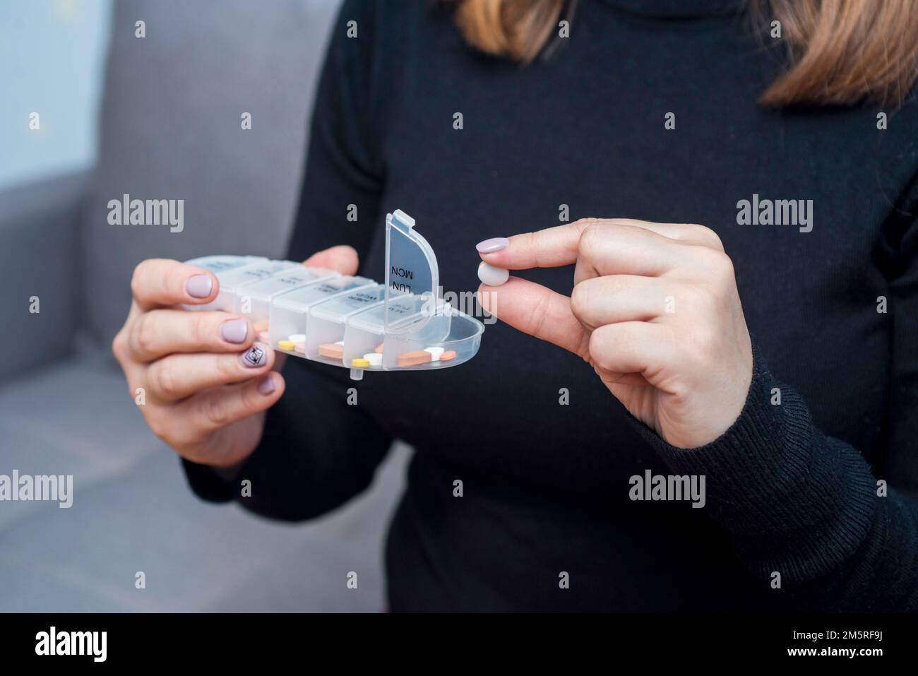 Woman pouring medication from hi-res stock photography and images - Alamy