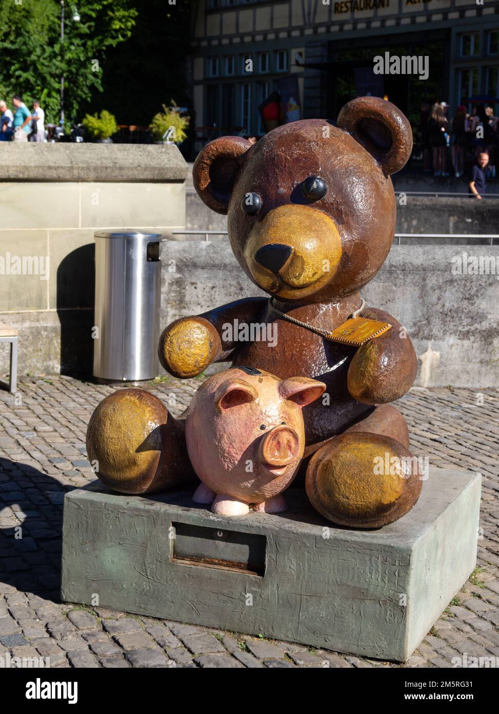 Bern, Switzerland - July 7, 2022: A teddy bear with a piggy bank in the ...