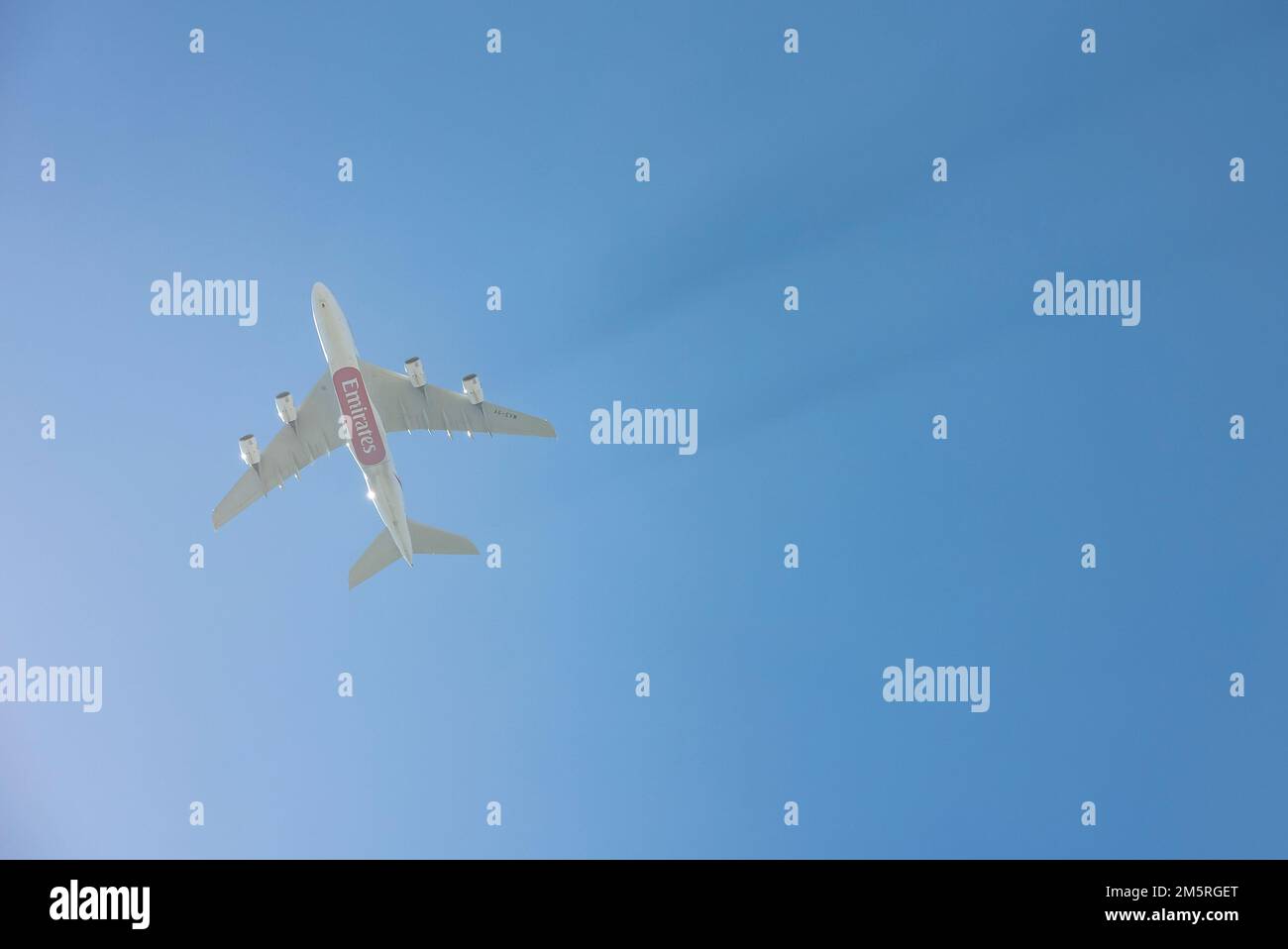 Airplane flying in mid-air with clear blue sky in the background Stock ...