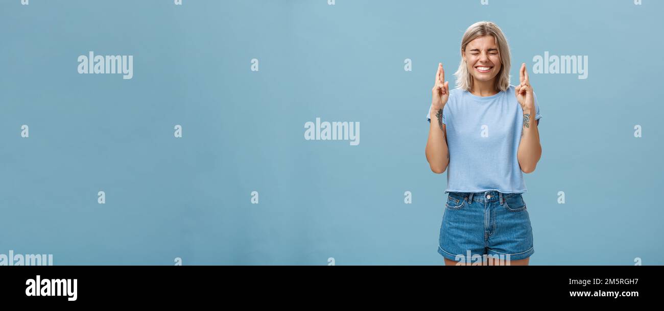 Optimistic faithful good-looking young woman with blond hair and ...