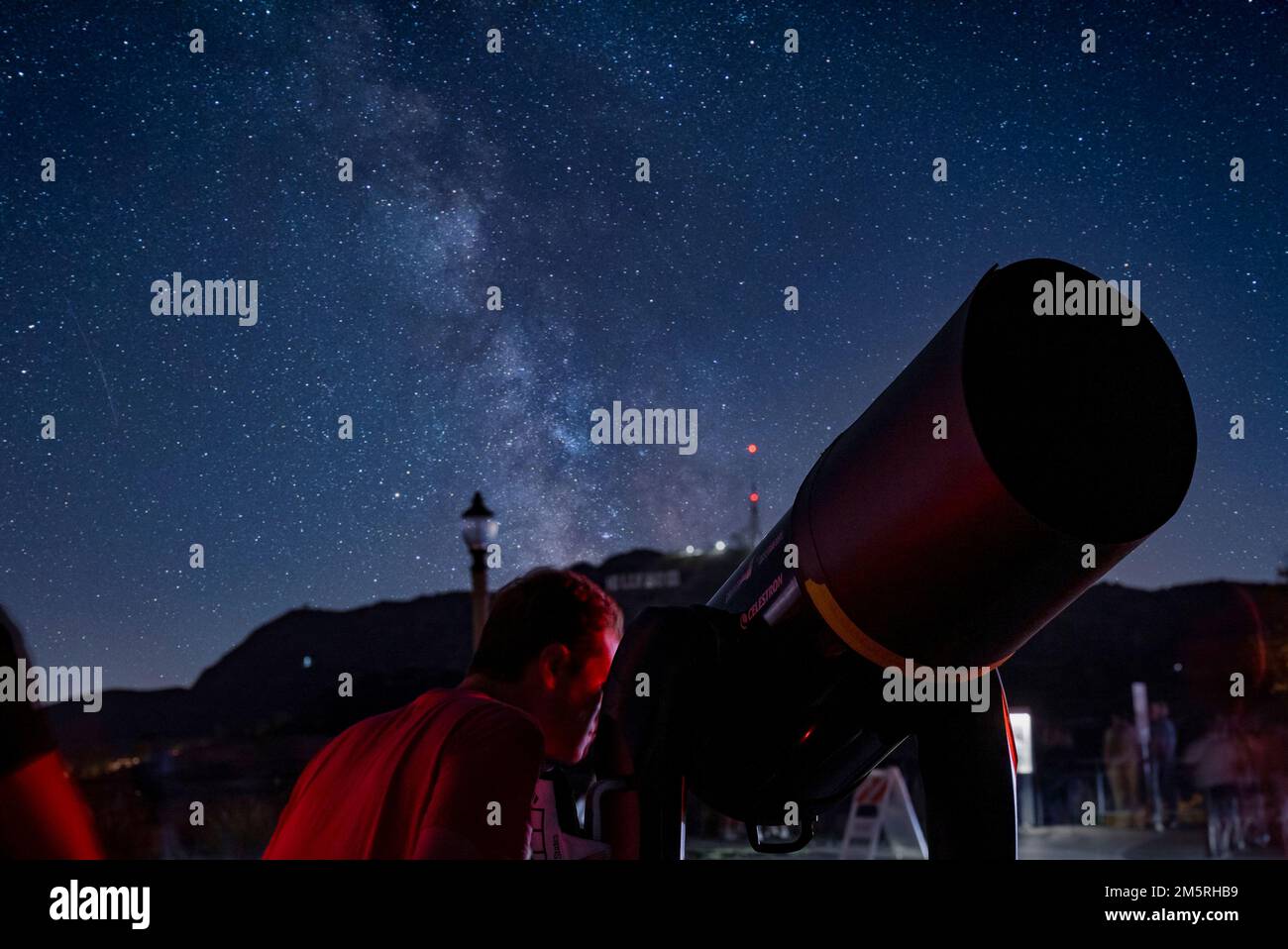 Man looking through telescope at Griffith Observatory by mount ...