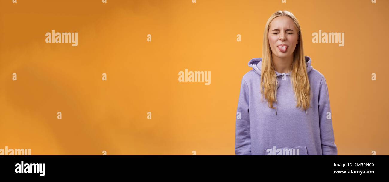 Playful amused charismatic young funny blond girl having fun close eyes ...