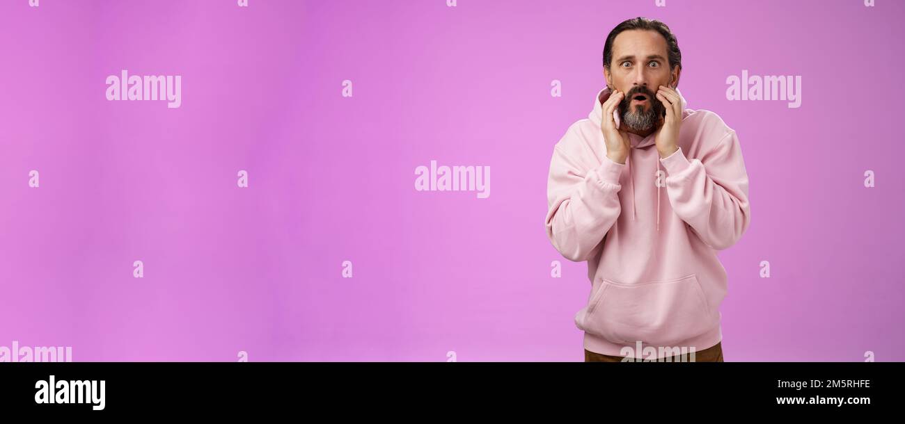 Impressed surprised handsome adult bearded man grey hair attend barber ...