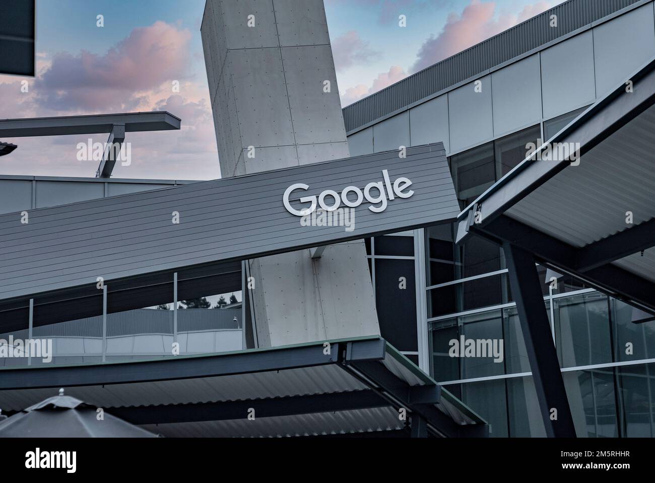 Exterior of modern google office building with logotype during sunset ...