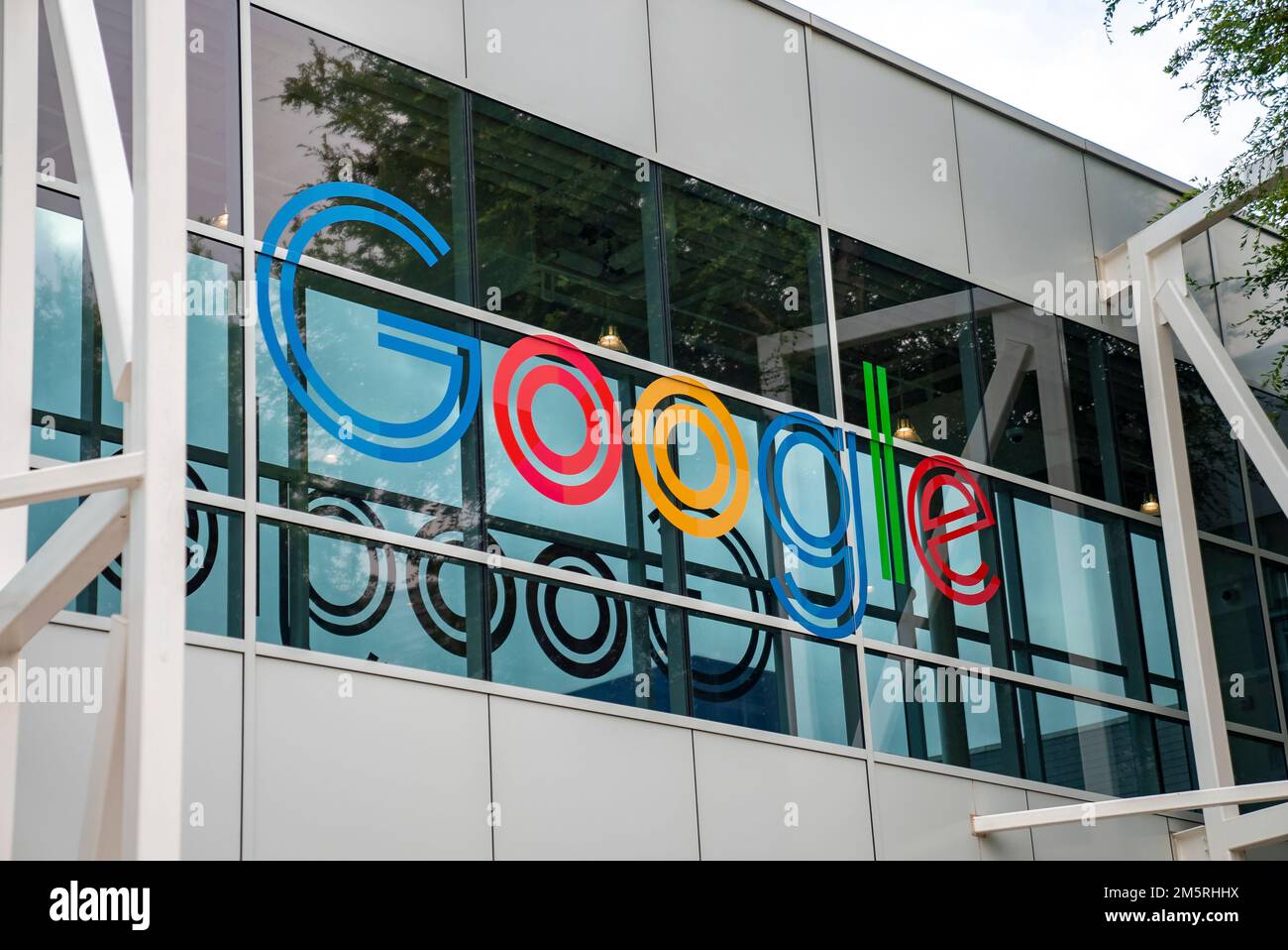 Detail shot of modern google office building with multi colored logo ...